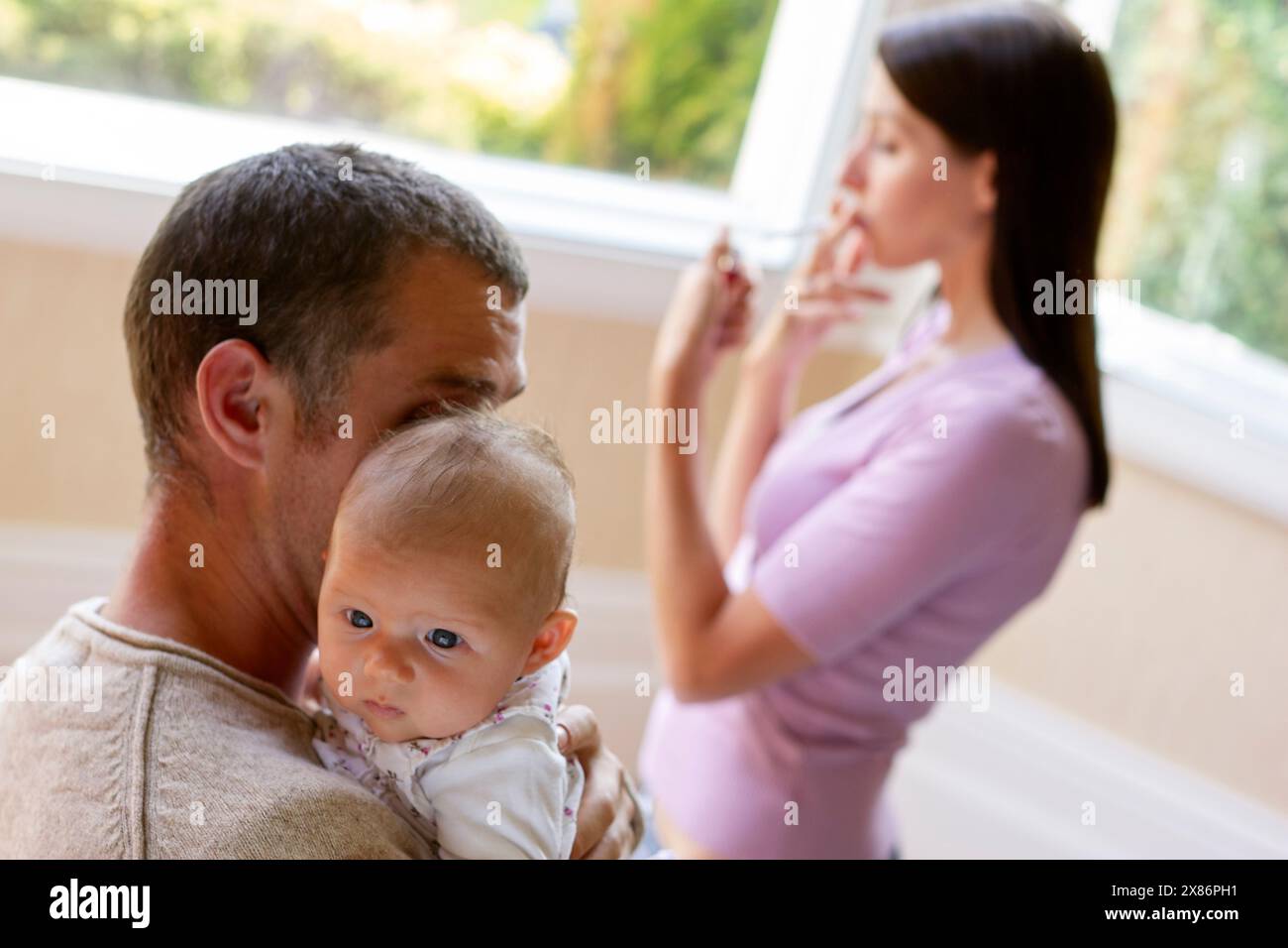 Woman smoking next to newborn baby Stock Photo - Alamy