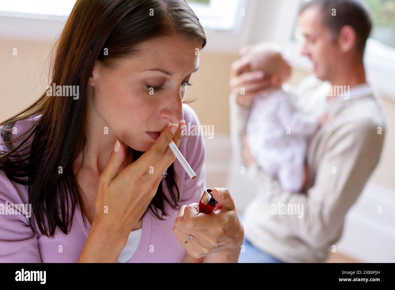Woman smoking next to newborn baby Stock Photo - Alamy
