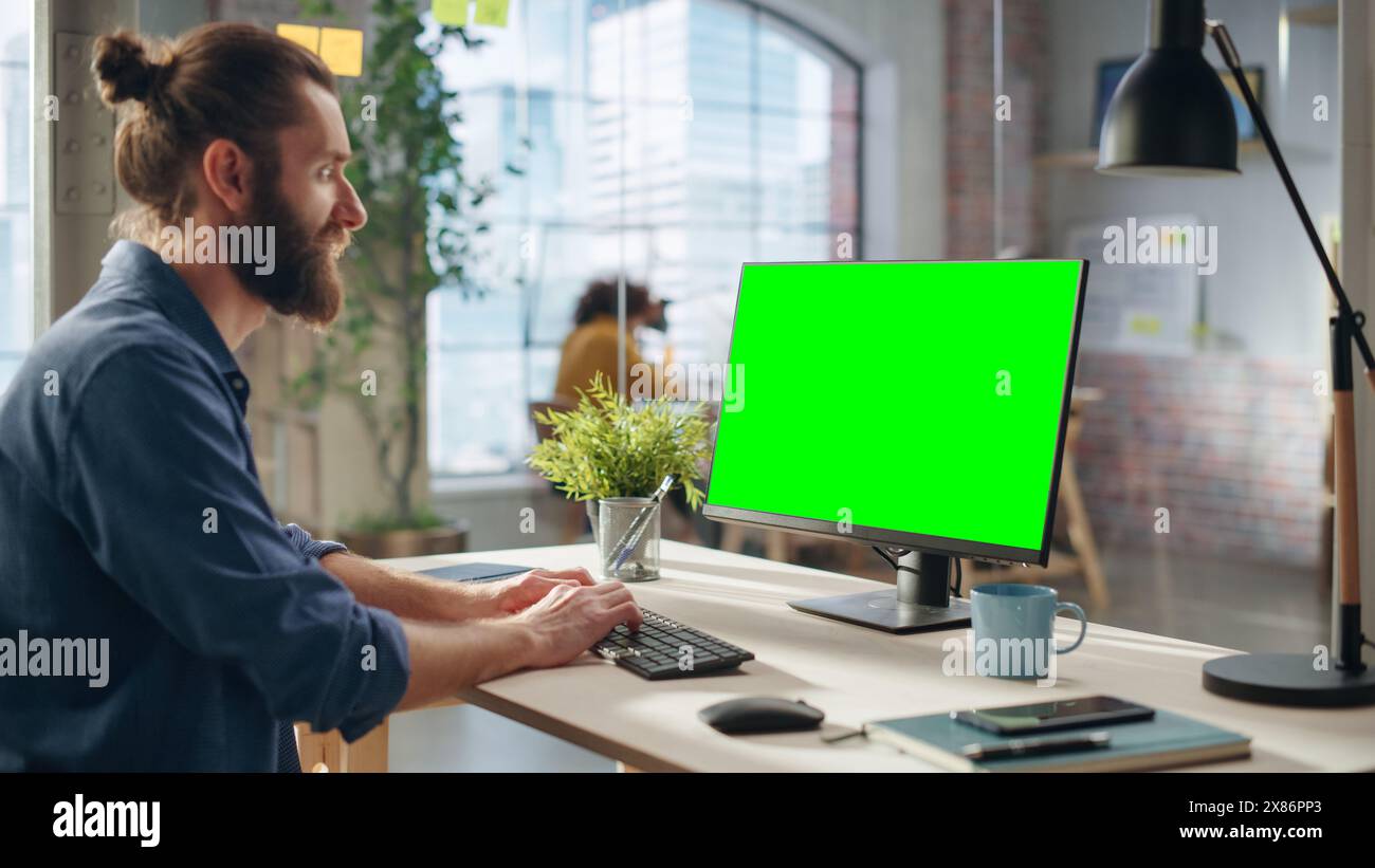 Creative Project Manager Working on Desktop Computer with Green Screen Mock Up Display. Bohemian ...