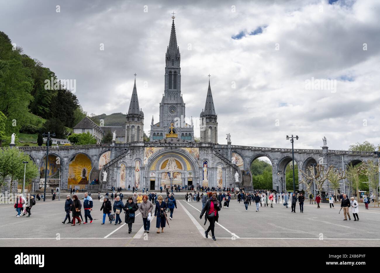 Lourdes, France - 17 April, 2024: many pilgrims visiting the Sanctuary of Our Lady of Lourdes on ...