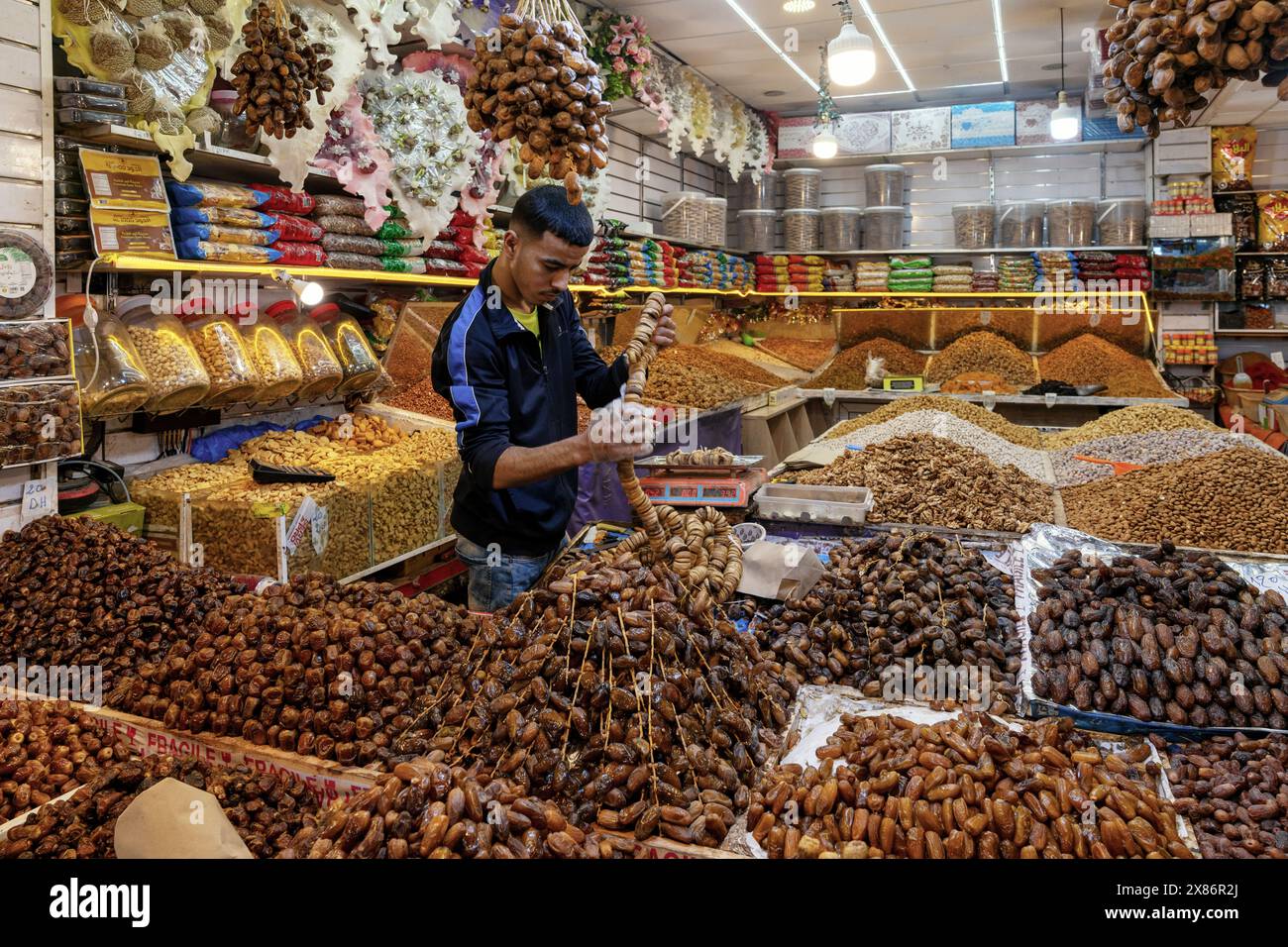 Taroudant, Morocco - 21 March, 2024: shopkeeper selling dates and figs ...