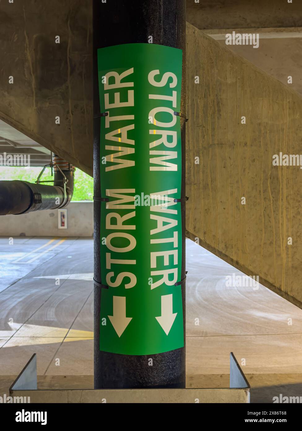 Closeup view of a metal pipe labeled storm water within a concrete ...