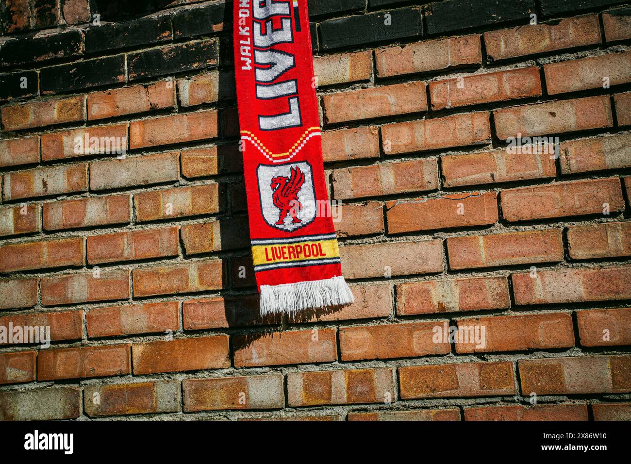 Liverpool FC scarf with brick wall Stock Photo - Alamy