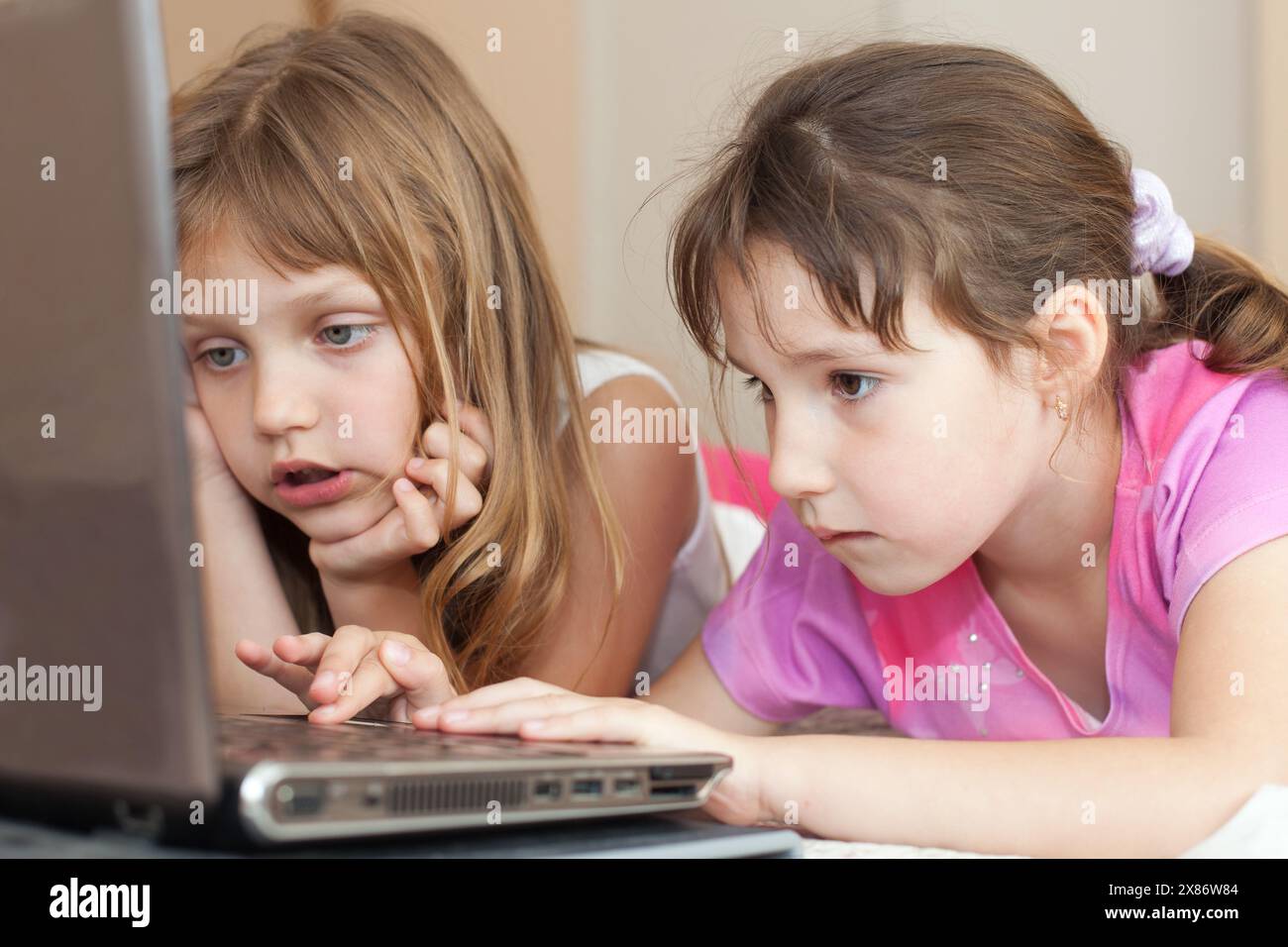 two little girls using computer Stock Photo - Alamy