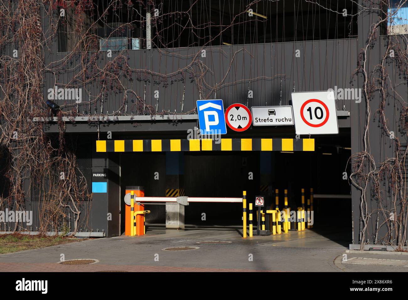 Entrance barrier and warning signs for underground parking under ...