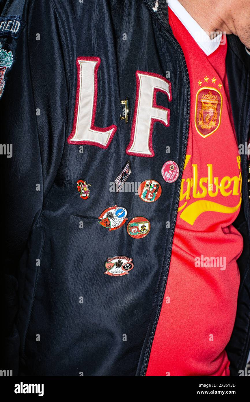 Liverpool FC supporter with pins and badges Stock Photo - Alamy