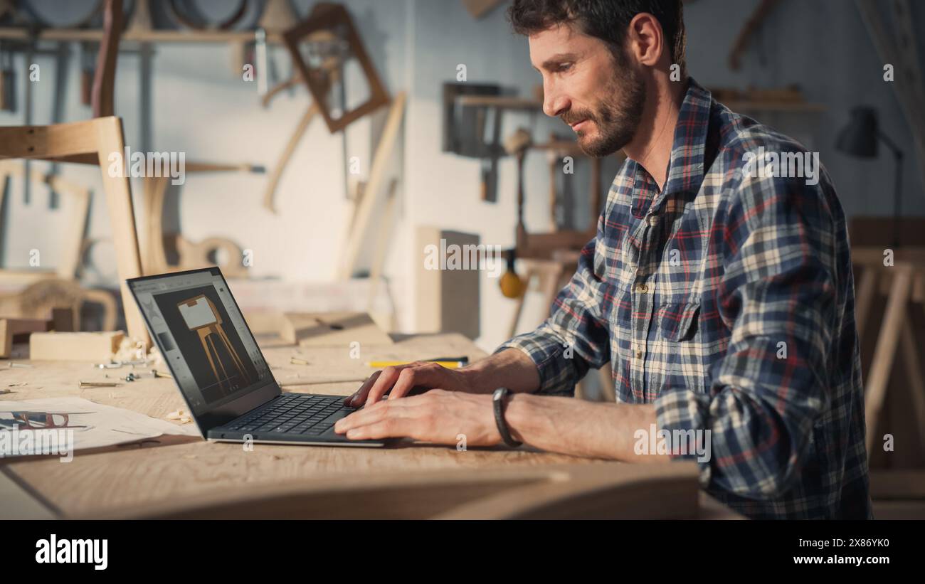 Handsome Furniture Designer Working on Laptop Computer, Creating a ...