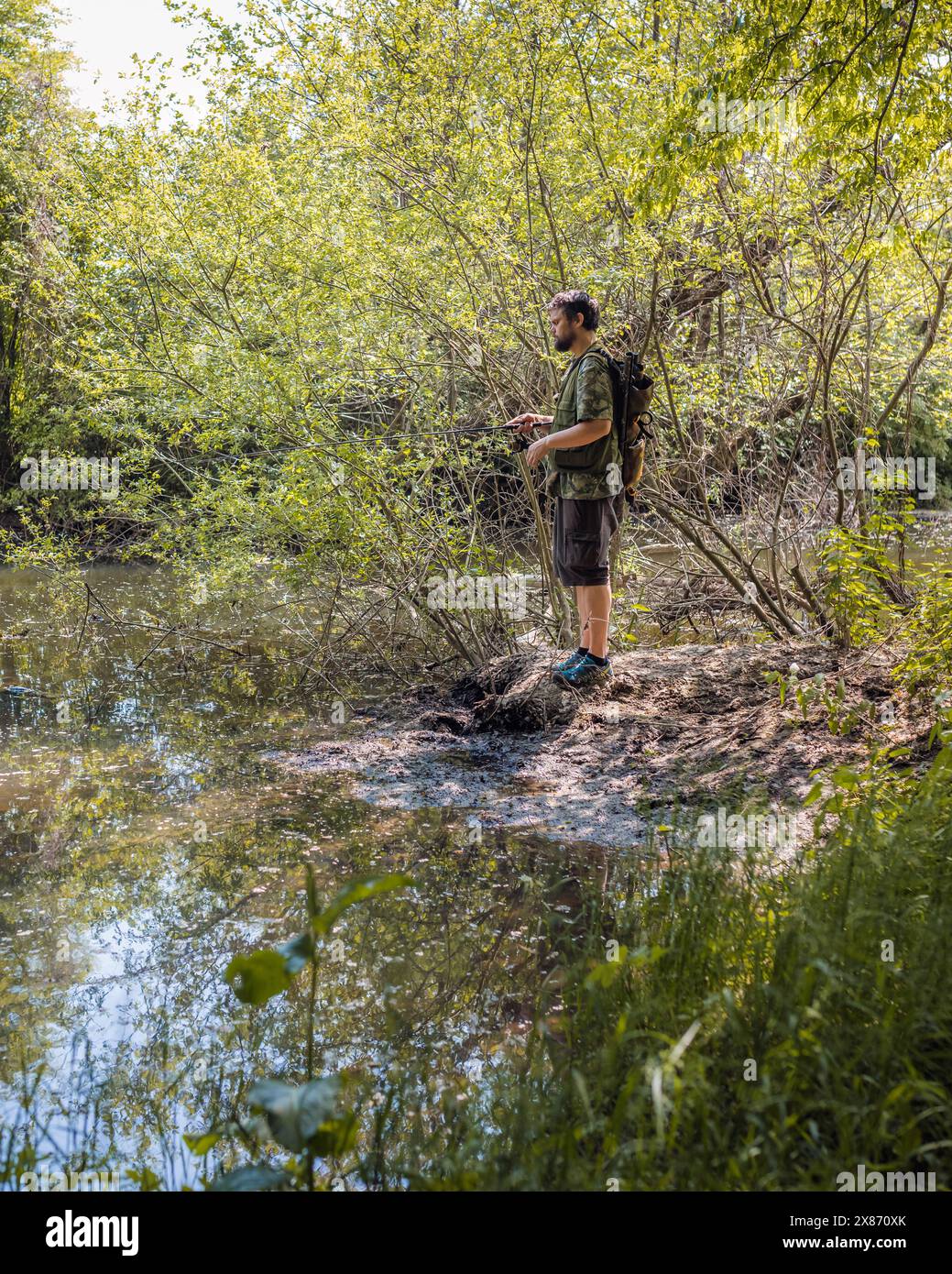 Recreational fisherman at river bank trying to catch a fish. Angler ...