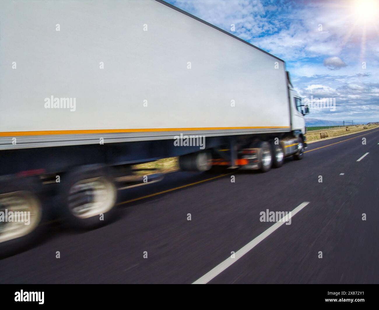 motion blur of truck speeding on the highway at sunset, haulage and ...