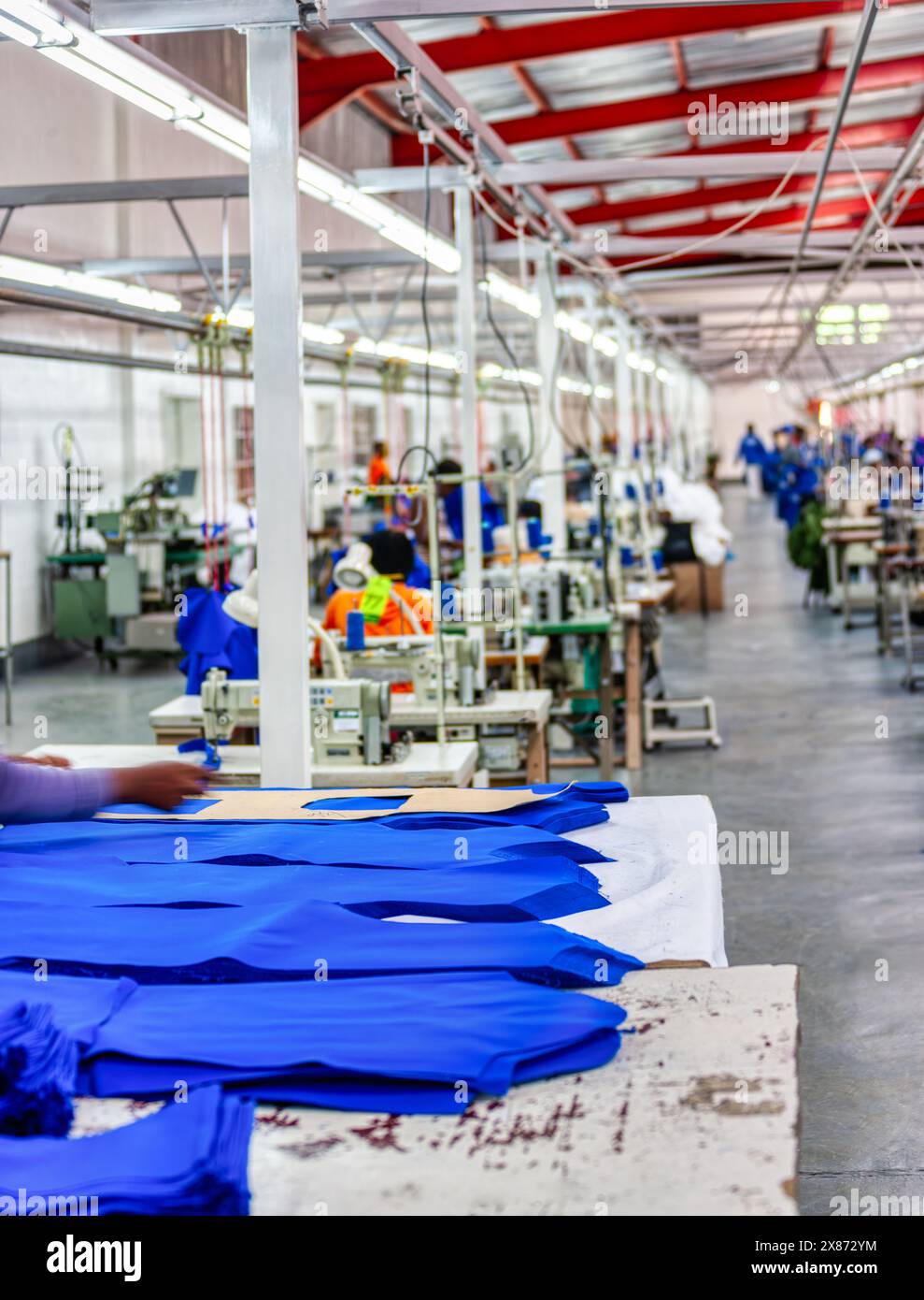 textile factory with pattern cutting table and sewing machines, industrial economic african ...
