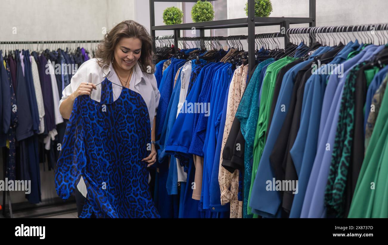A fat woman chooses clothes in a plus size store Stock Photo - Alamy