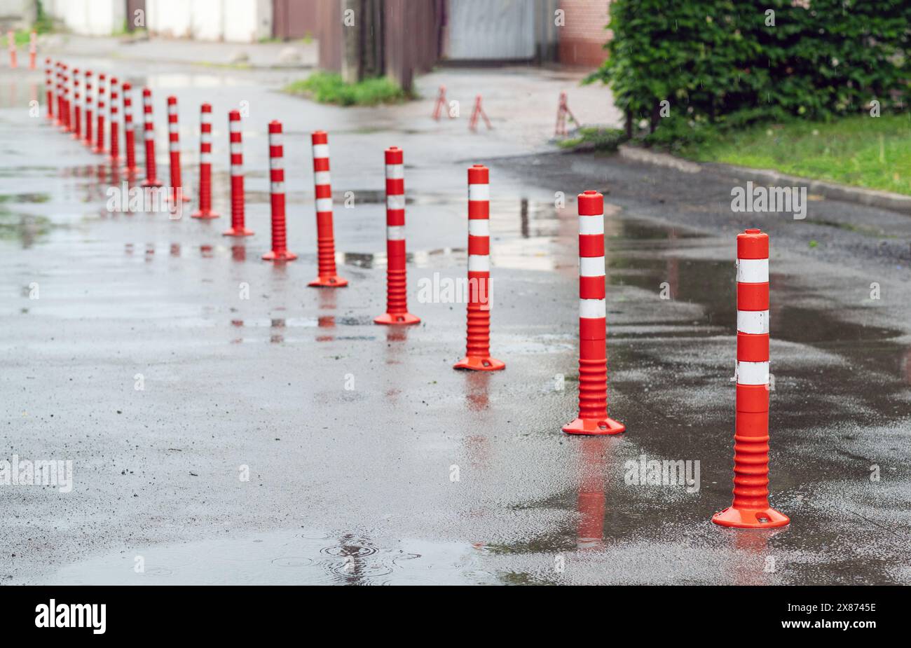 Road sign flexible plastic bollards with pedestrian white marking line and arrow sign on cement ...