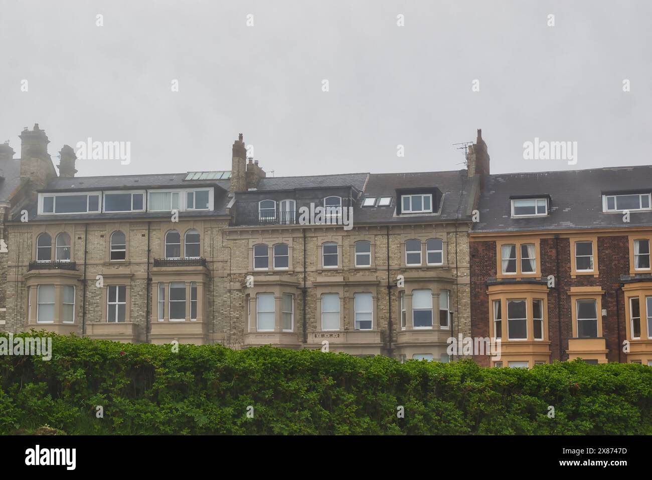 A row of old, multi-story residential buildings with various ...