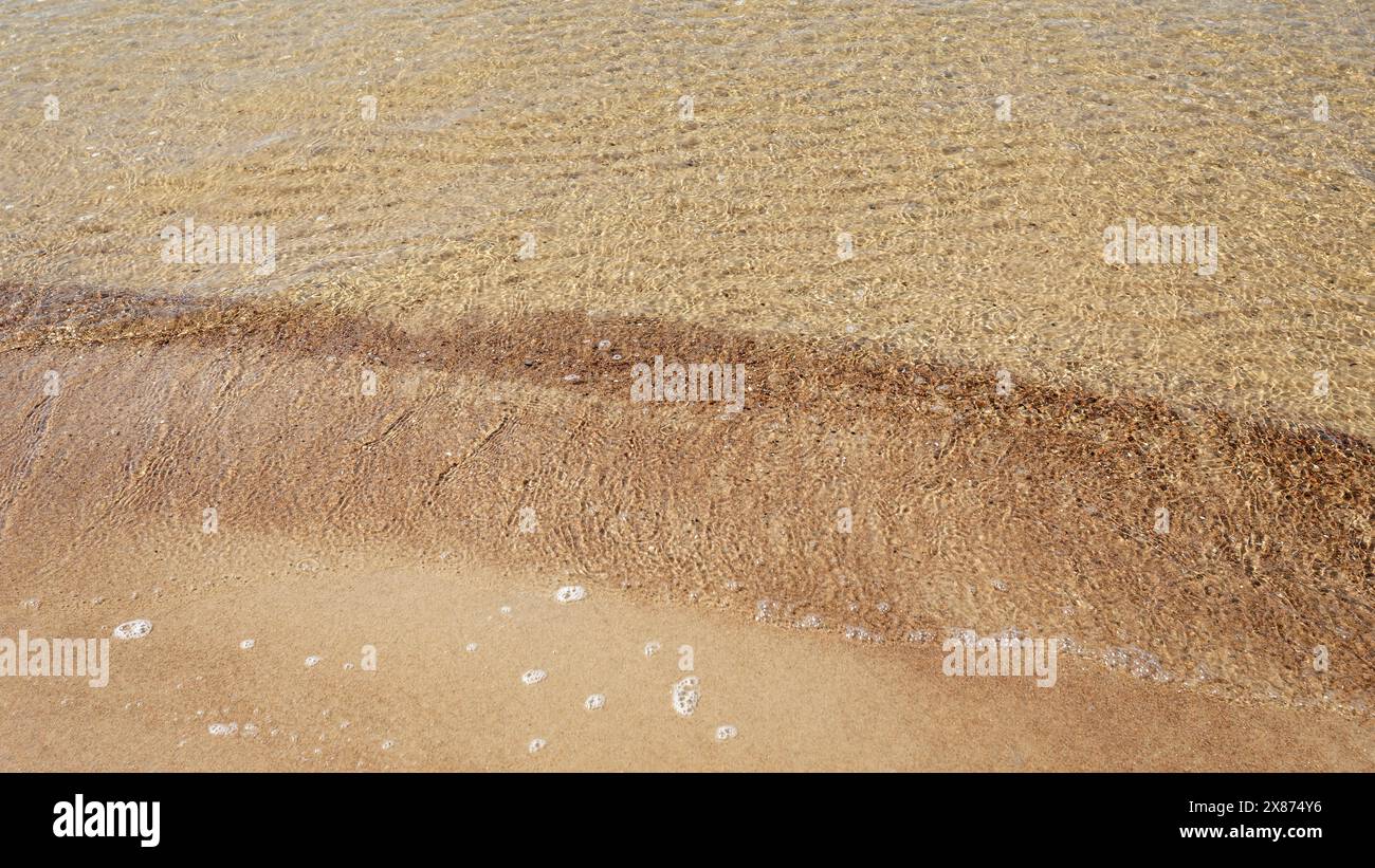 Sea water touch wet sand. Summer holiday to Baltic sea. Empty sandy ...