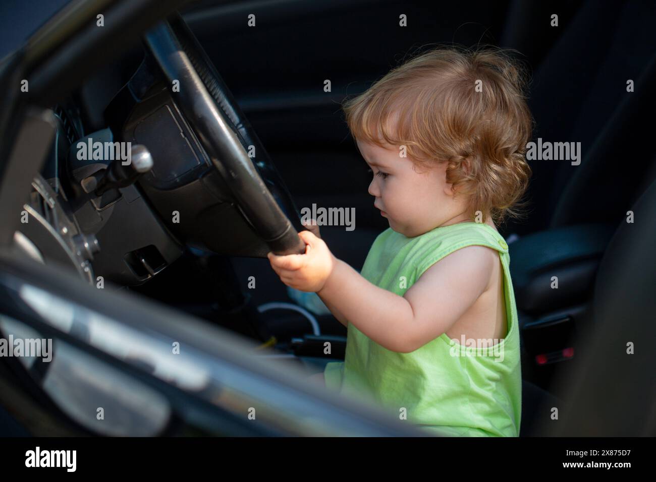 Child Driver. Baby in car with his hands on the wheel. Child Driver ...