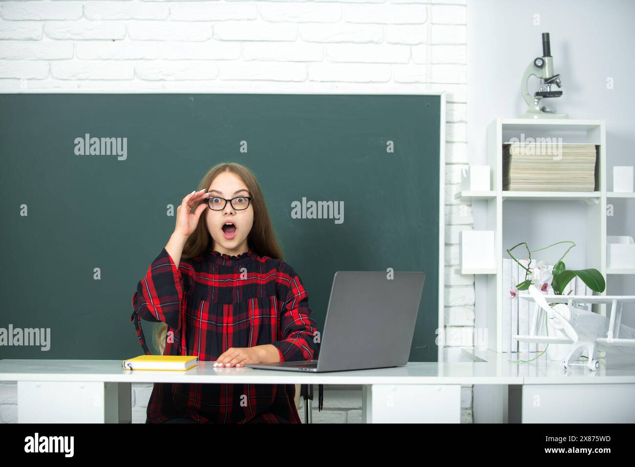 Surprised little student. Portrait of school girl in classroom. School ...