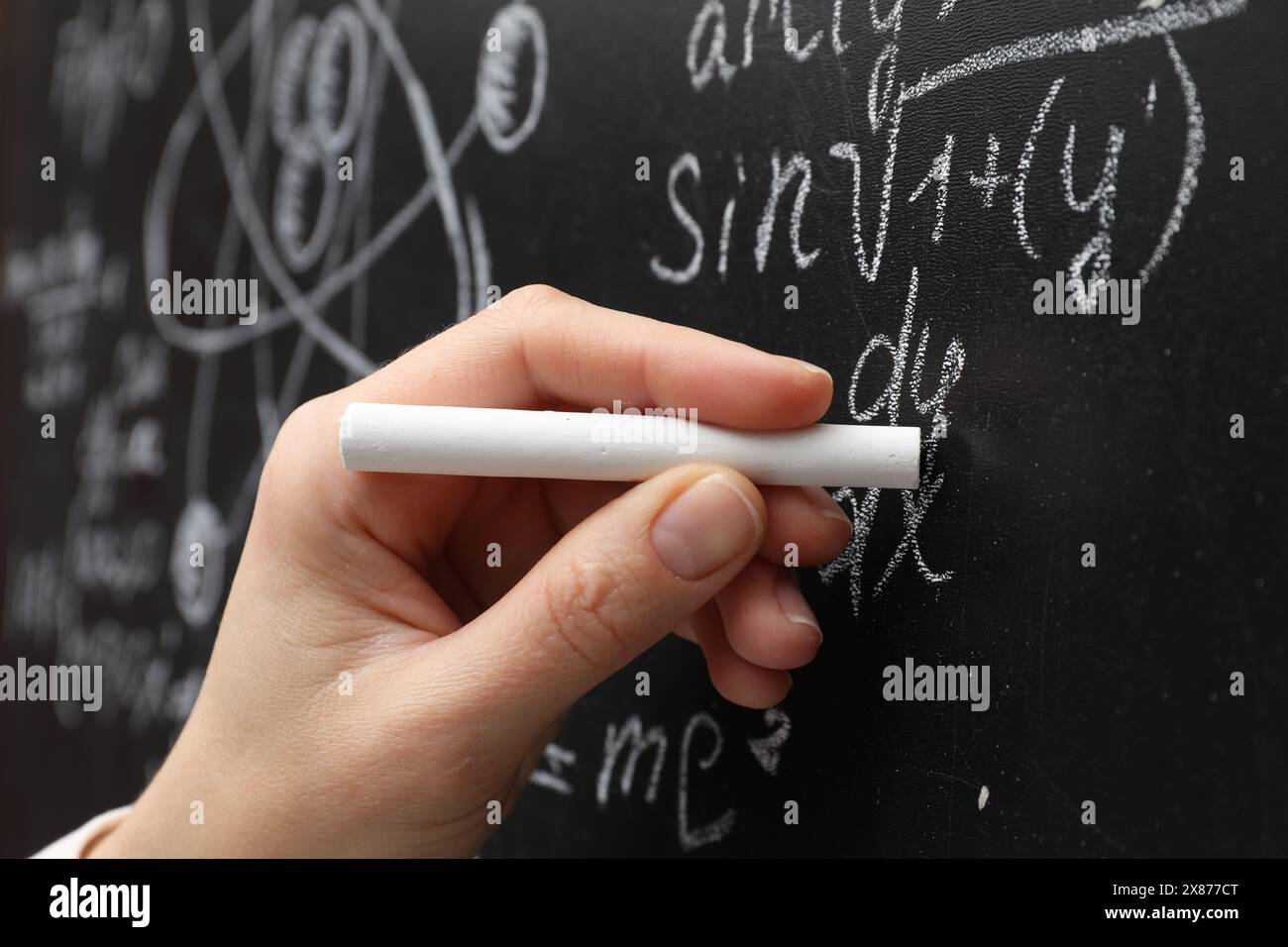 Teacher writing math formulas with chalk on blackboard, closeup Stock ...
