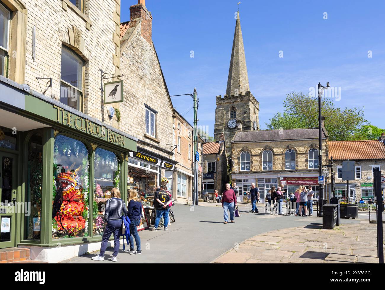 Pickering Market Place and shops on Birdgate with the tower of St Peter ...