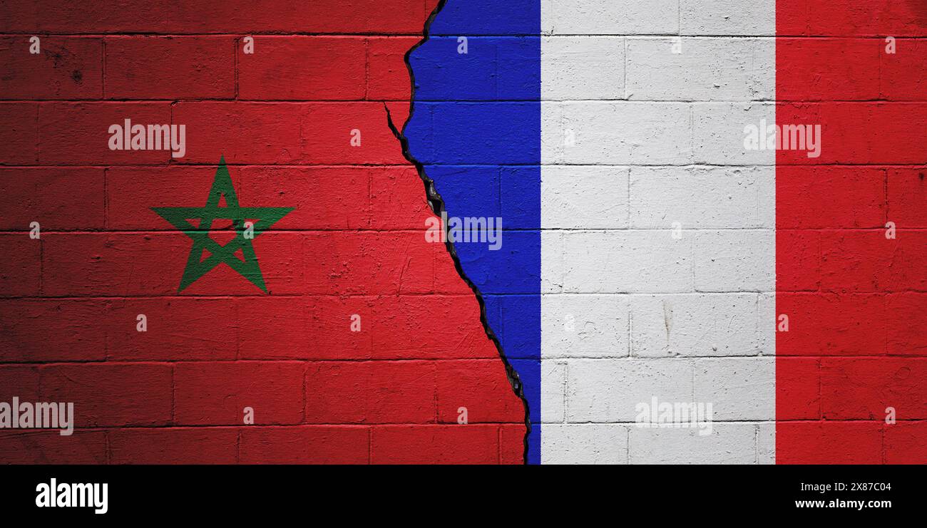 Cracked cinder block wall painted with a flag of Morocco on the left ...