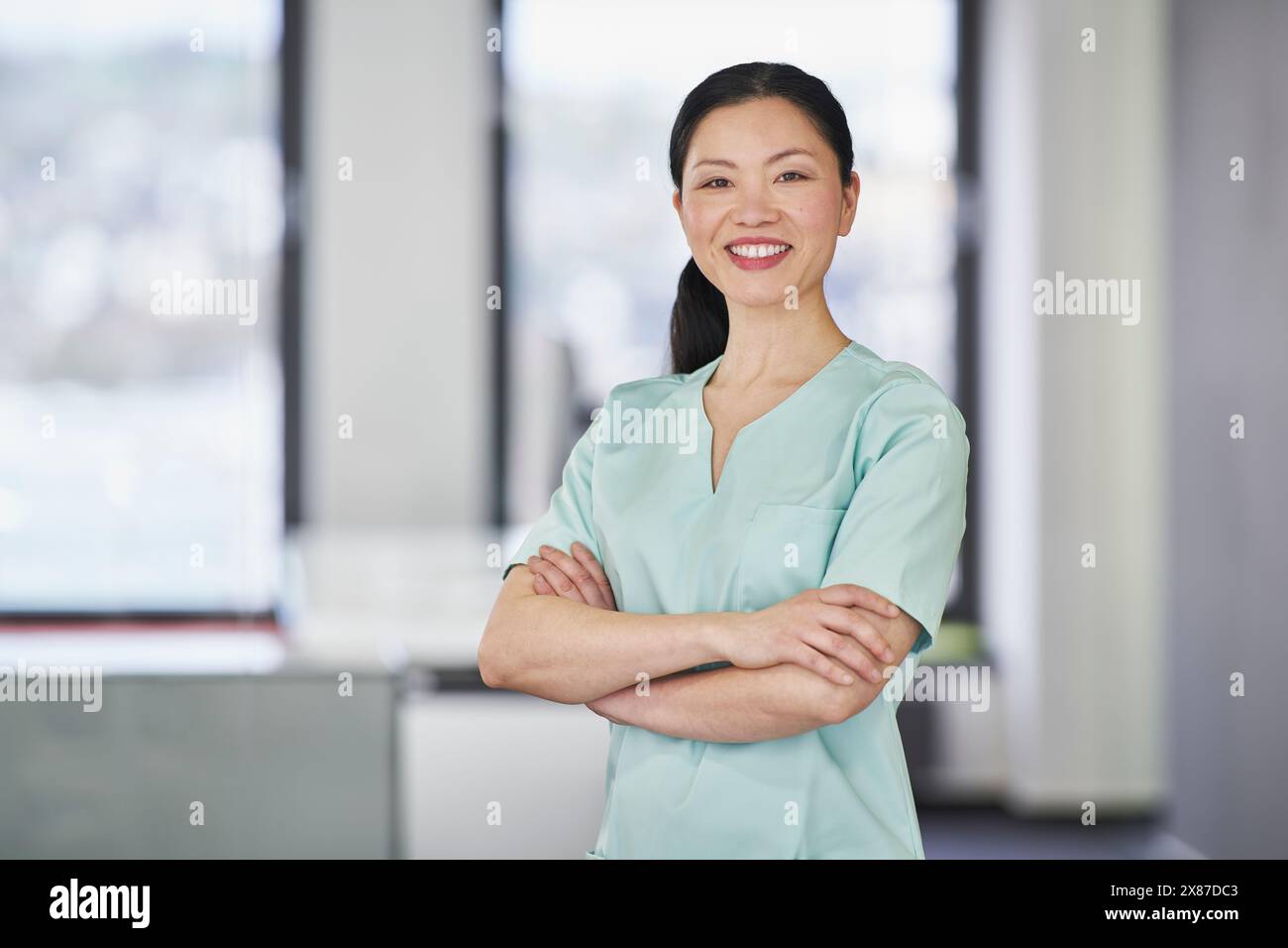 Portrait of smiling nurse in scrubs Stock Photo - Alamy