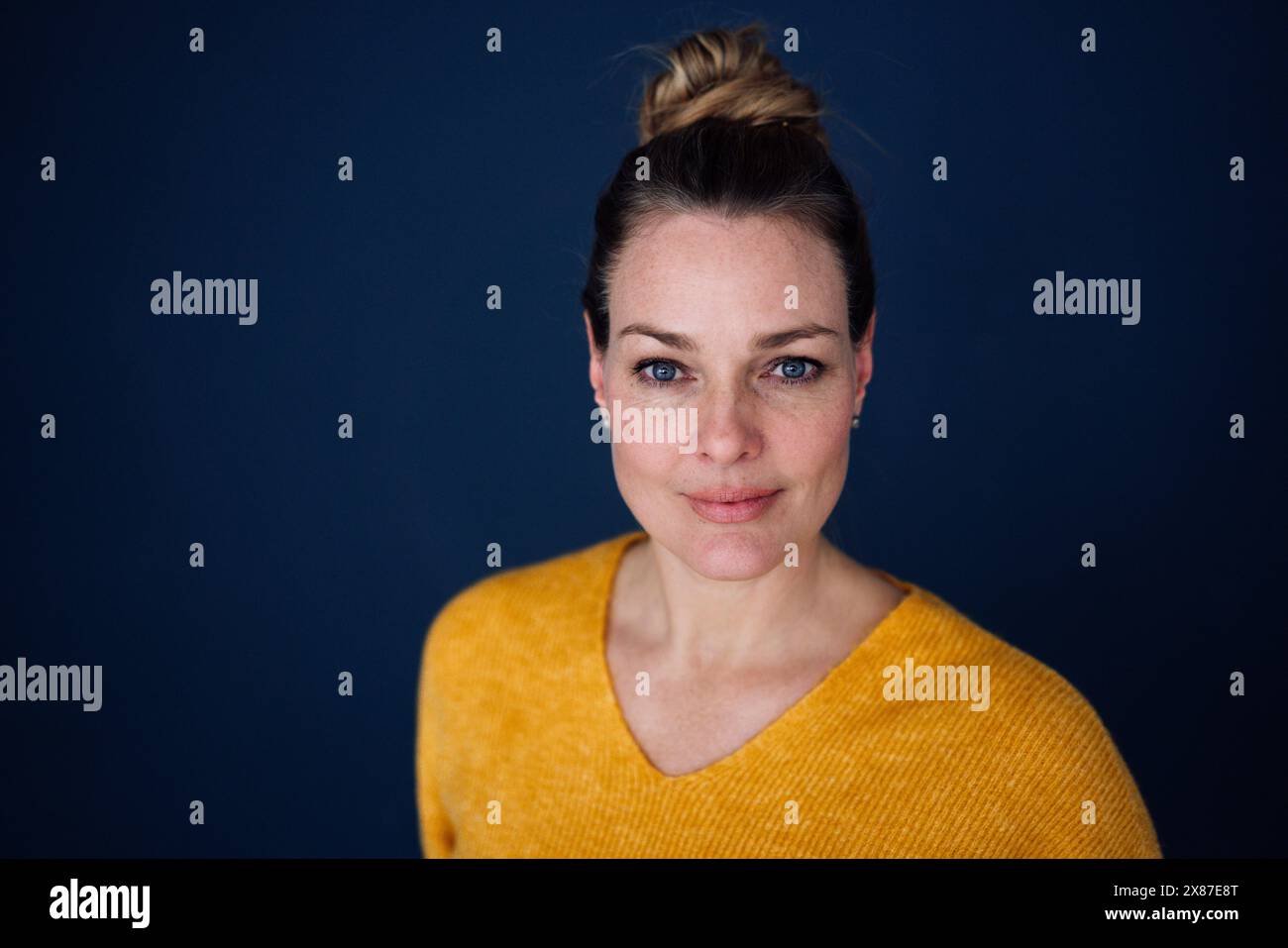 Confident beautiful woman against colored background Stock Photo - Alamy