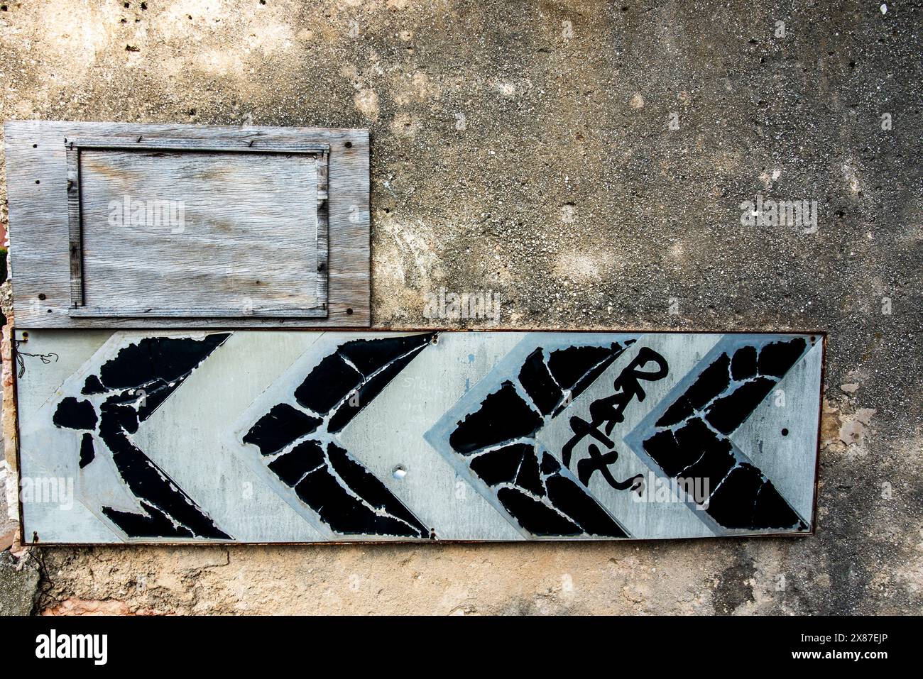old dangerous bend sign ruined by time hanging on the wall of an old ...