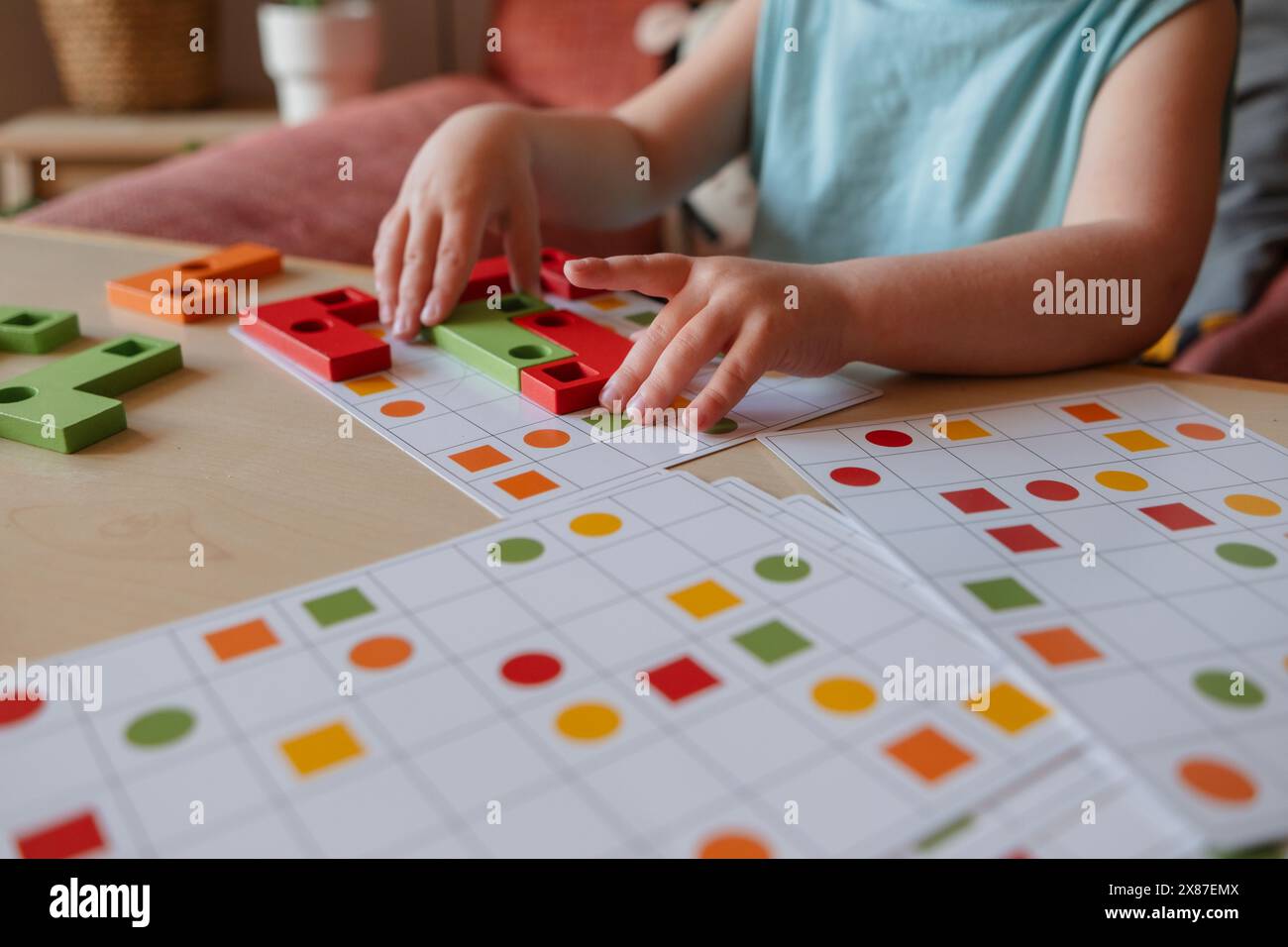 Boy playing educational wooden game on table at home Stock Photo - Alamy
