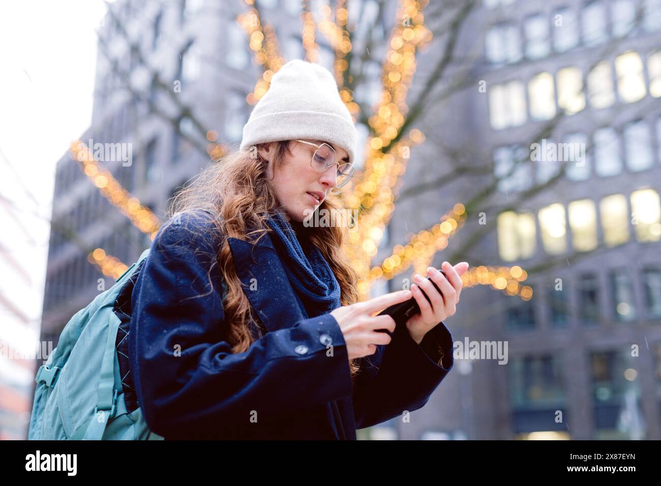 Woman near christmas tree using hi-res stock photography and images - Alamy