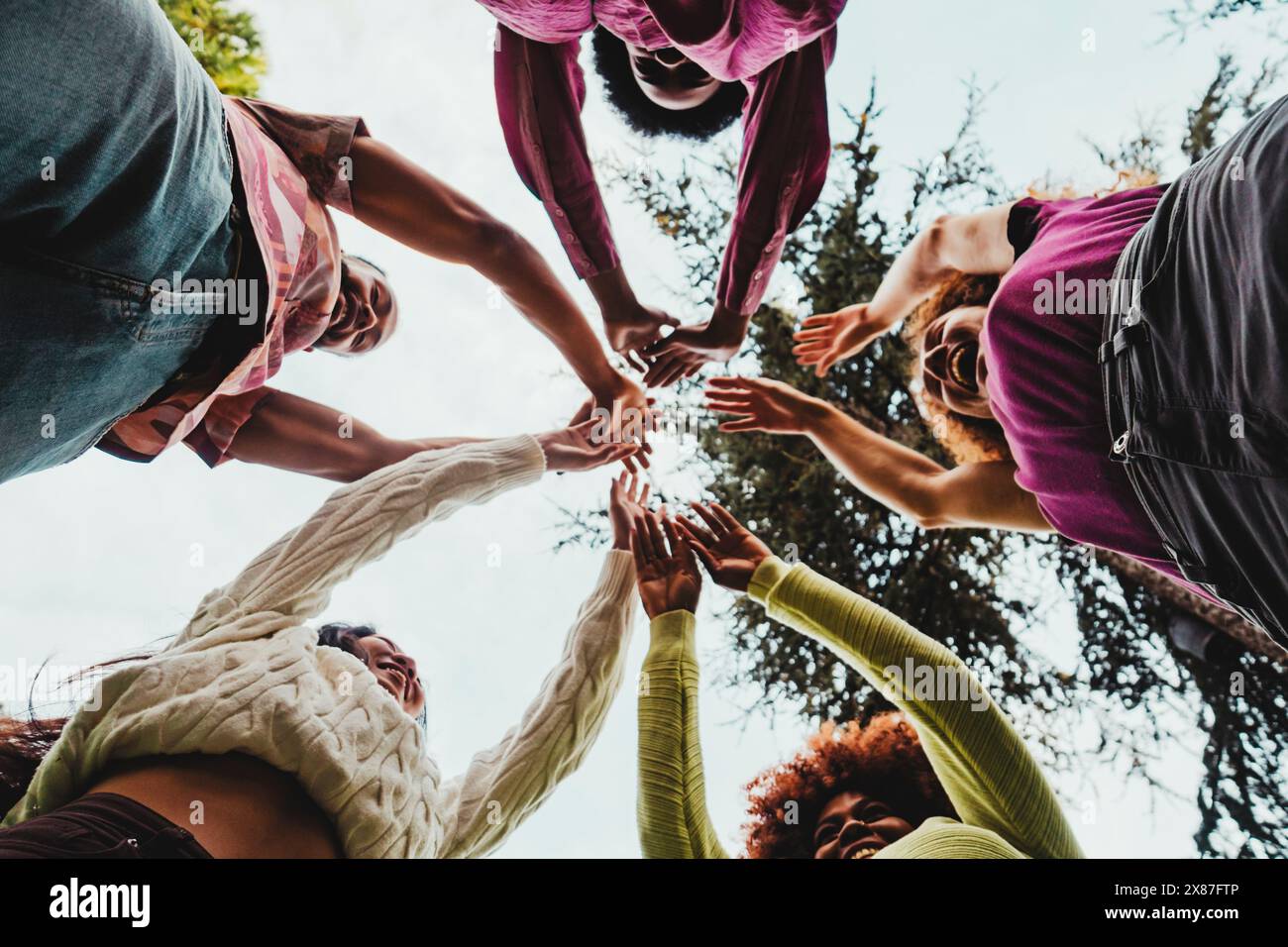 Carefree multiracial friends cheering with each other at park Stock ...