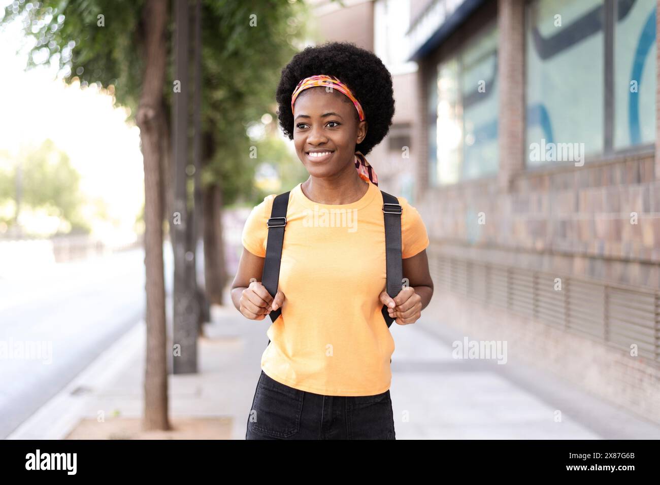 African female holding backpack hi-res stock photography and images - Alamy
