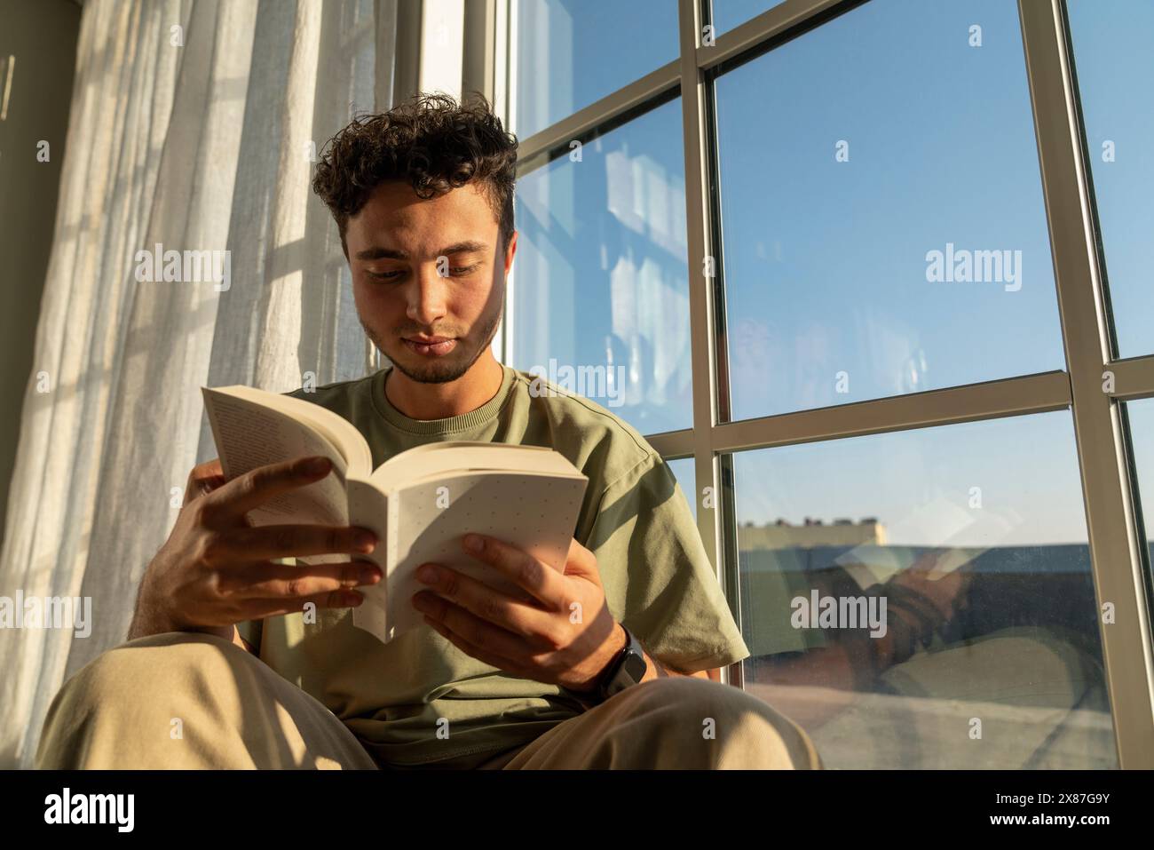 Interior with young man reading hi-res stock photography and images - Alamy