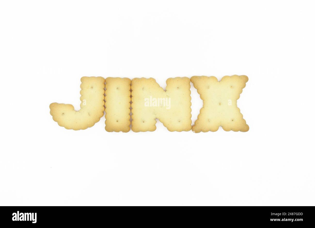 Capital letter shaped biscuits forming word JINX isolated on white ...