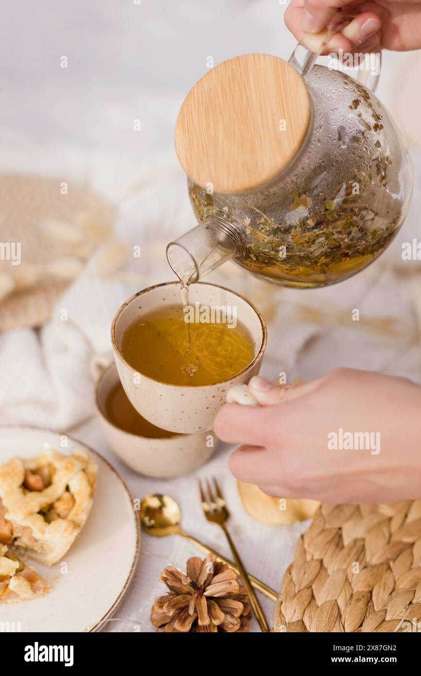 Hand pouring healthy herbal tea hi-res stock photography and images - Alamy