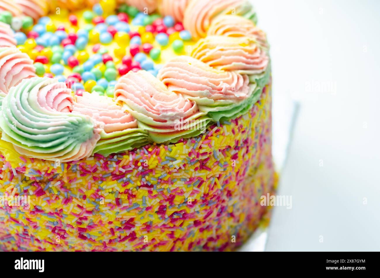 Madeira sponge coated with yellow colour frosting, layered with plum ...