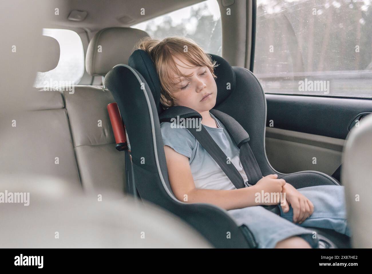 Tired boy sleeping on baby seat in car Stock Photo - Alamy