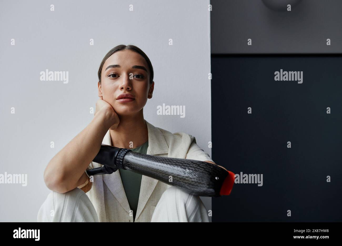 Young woman with black bionic arm at home Stock Photo - Alamy