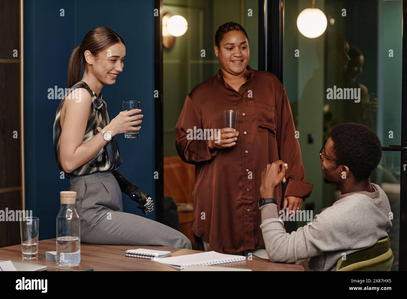 Happy diverse colleagues discussing at conference table in office Stock ...