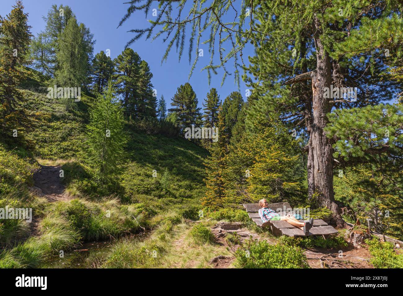Austria, Salzburger Land, Female hiker relaxing on mountain bench in ...