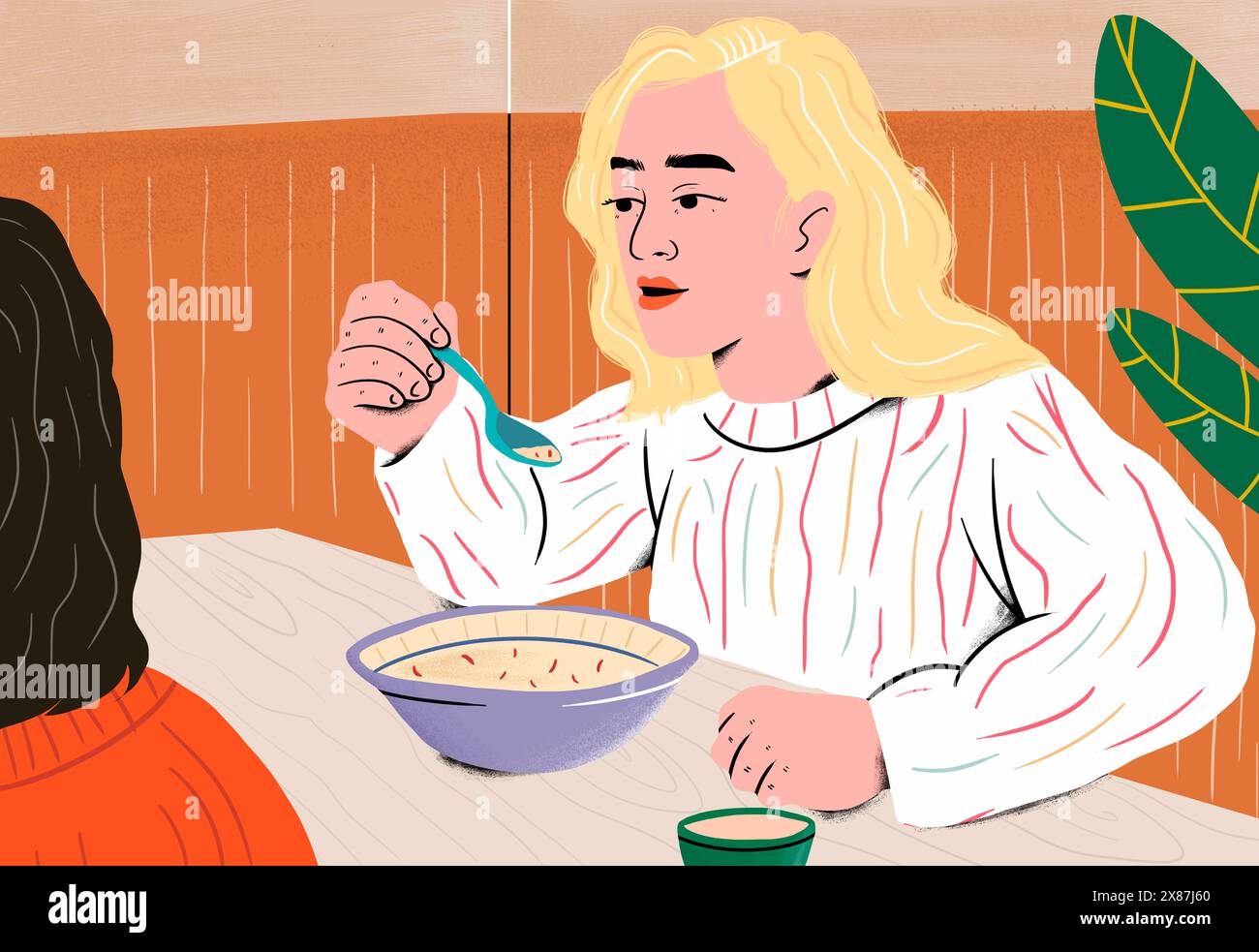 Blond woman eating soup and talking with friend at table Stock Photo ...