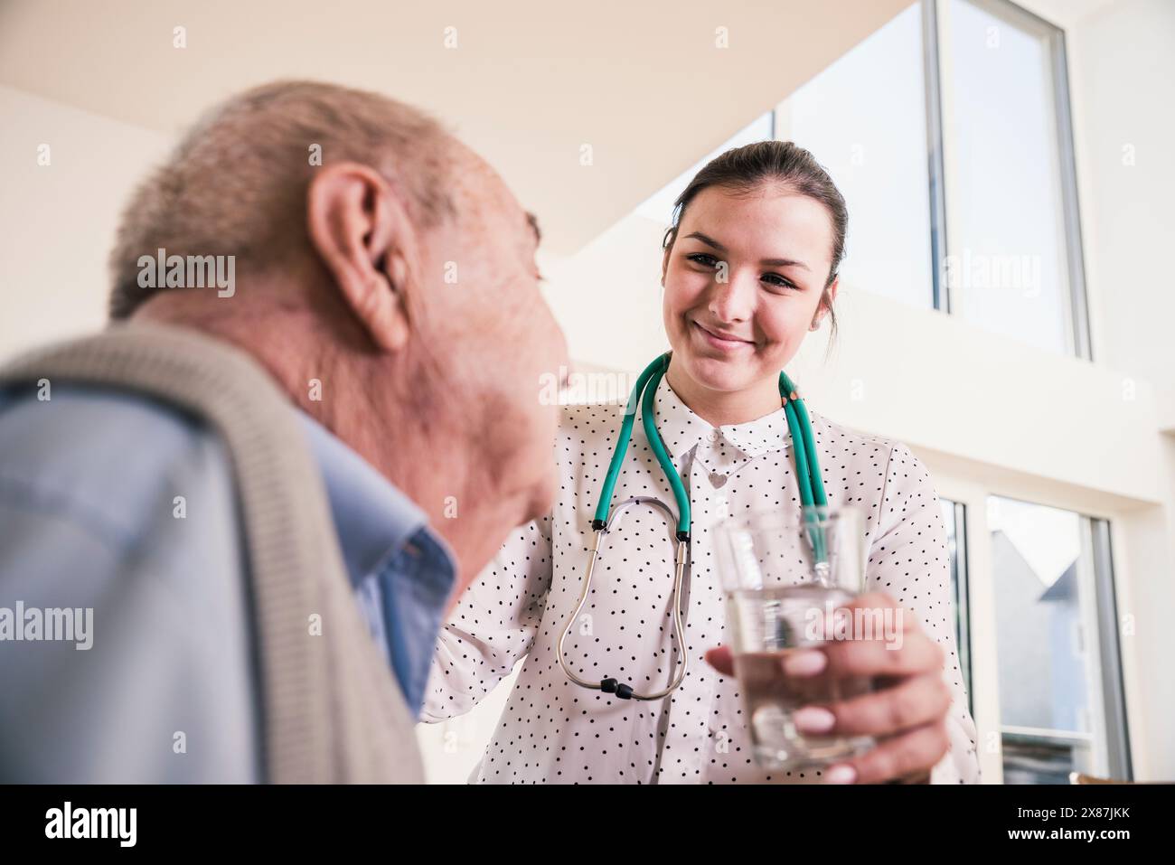 Female doctor drinking water hi-res stock photography and images - Alamy