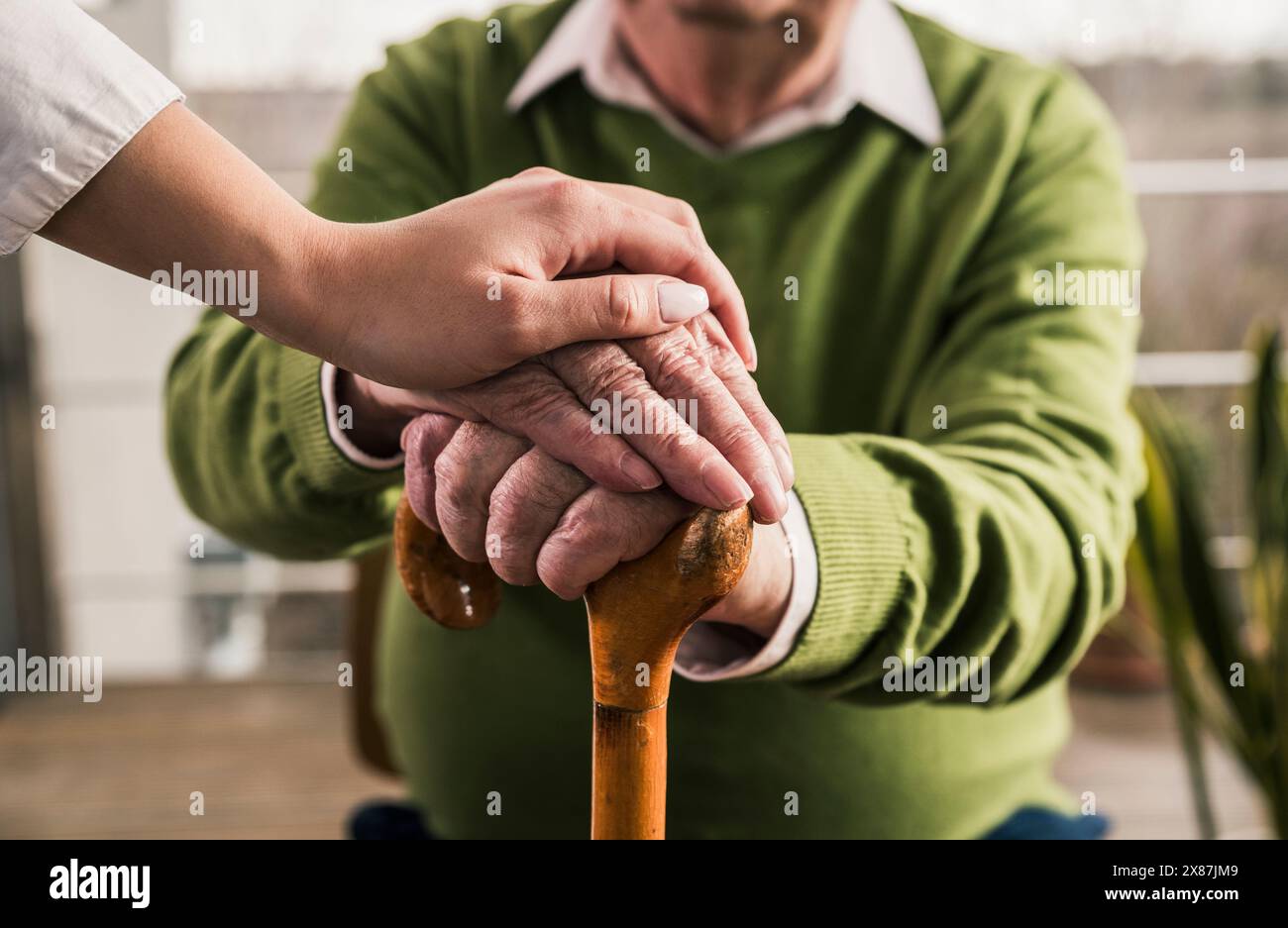 Hands of nurse and senior man on walking cane Stock Photo - Alamy