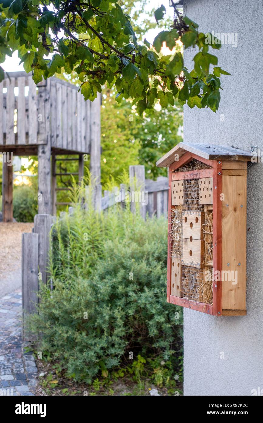 Insect hotel mounted on wall Stock Photo - Alamy