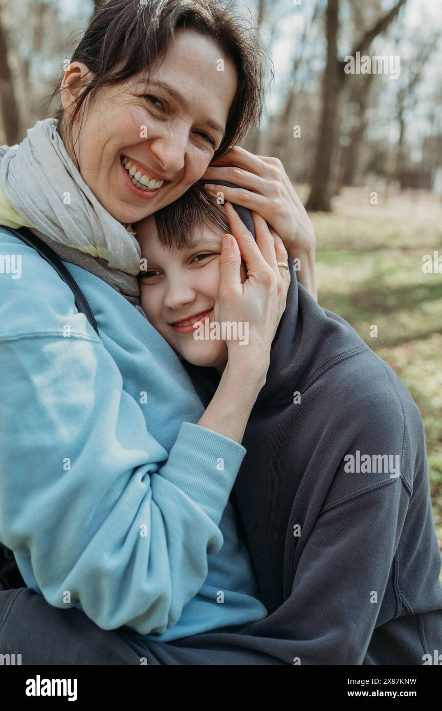 Happy mother hugging son at park Stock Photo - Alamy