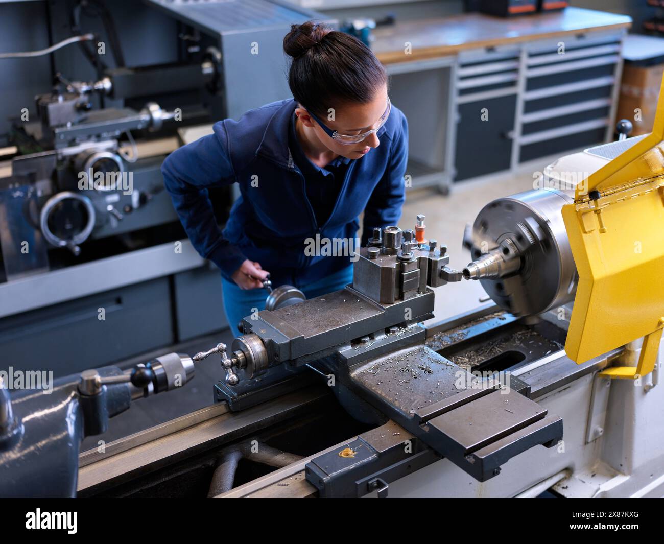 Engineer operating lathe in metal industry Stock Photo - Alamy