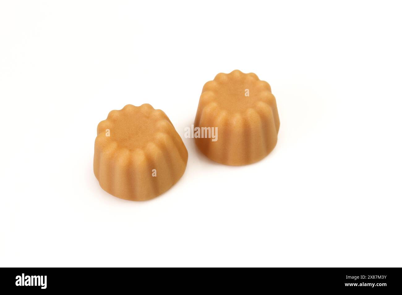 Two brown gummy jelly cupcake shaped candies isolated on white ...