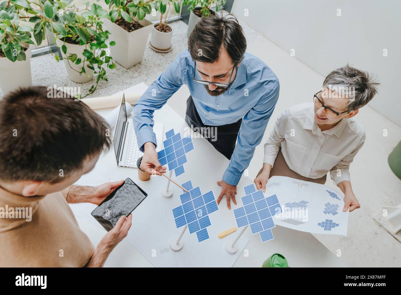 Business people working on solar panels project at desk Stock Photo - Alamy