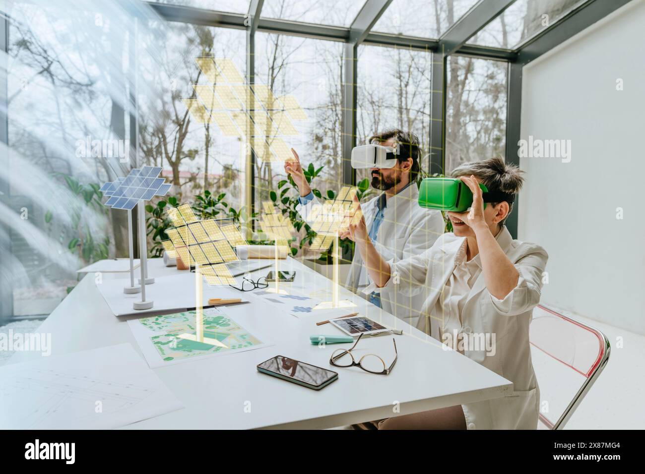 Engineers wearing virtual reality simulators and working on solar ...