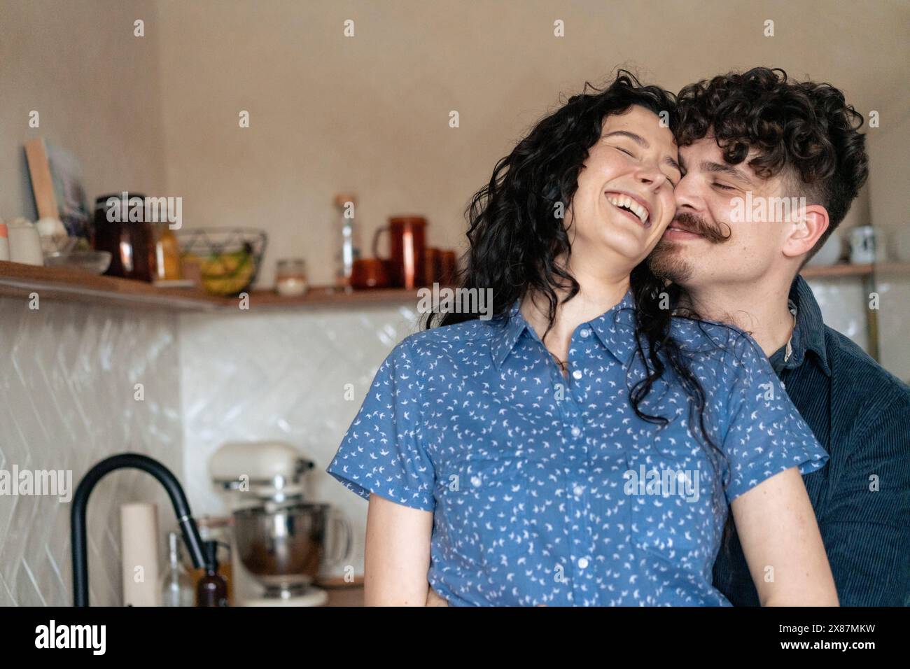 Romantic couple having fun in kitchen at home Stock Photo - Alamy