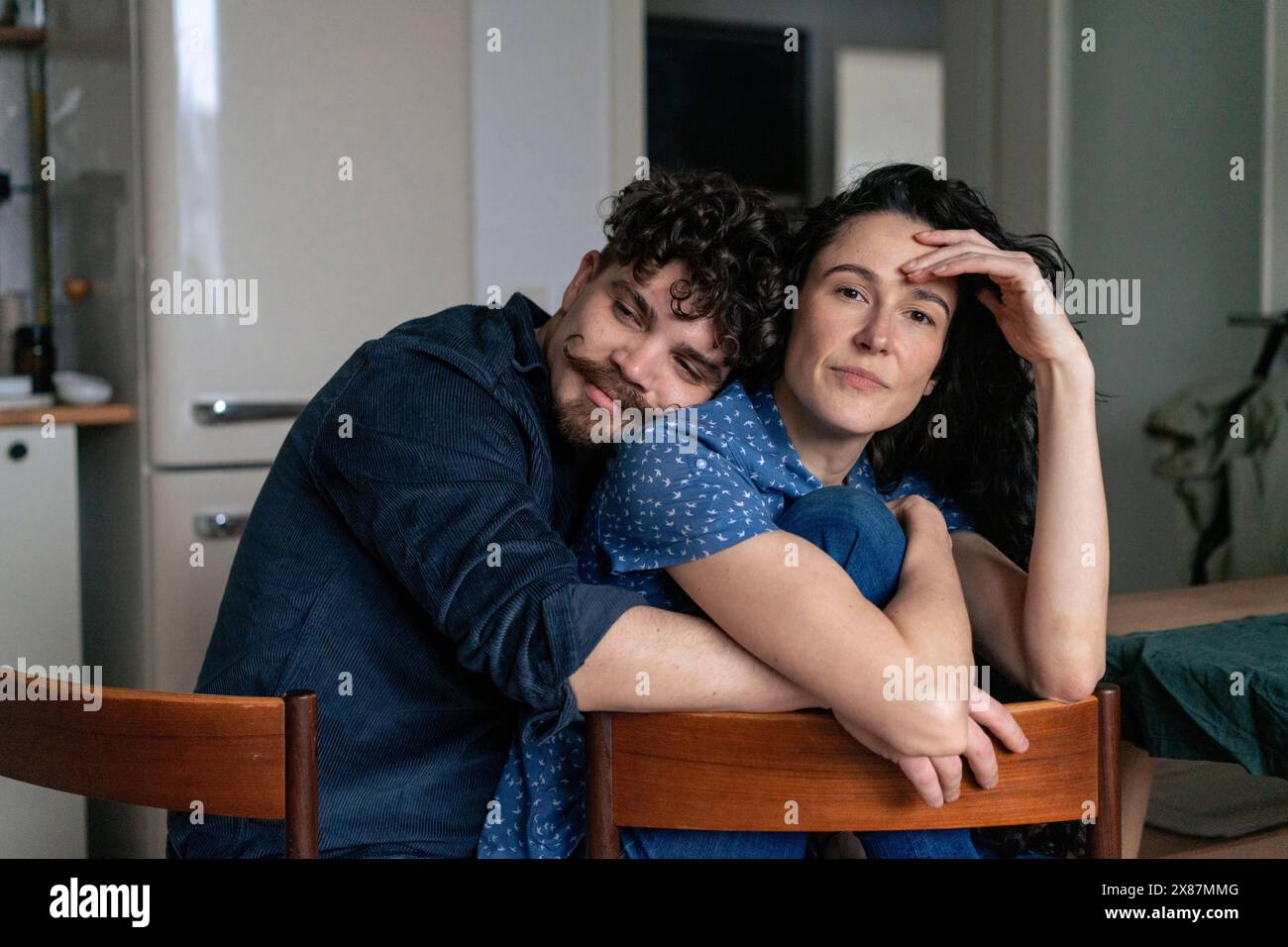 Couple sitting together on chairs at home Stock Photo - Alamy