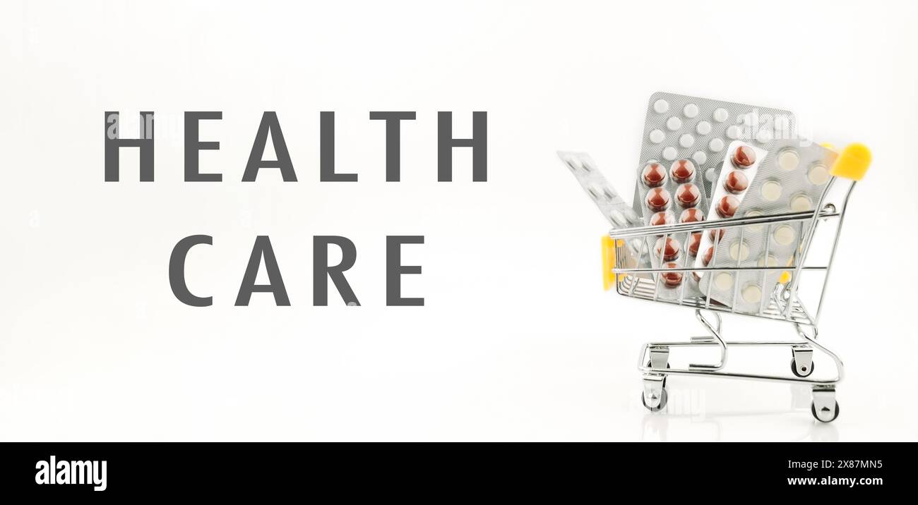 A cart full of medicine is labeled health care. The cart is silver and ...